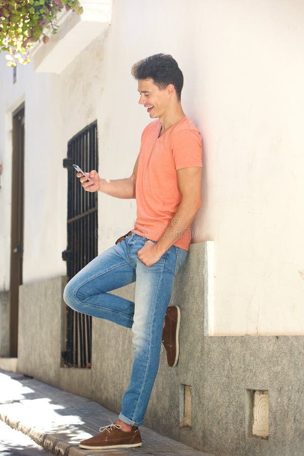 Smiling Man Reading Text Message on Mobile Phone Stock Photo - Image of ...