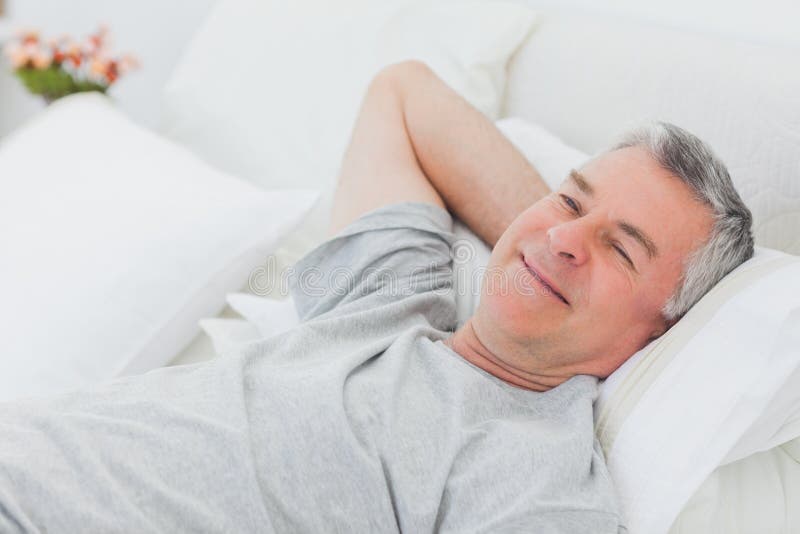 Smiling Man Relaxing in Bed Stock Photo - Image of abode, house: 31802636