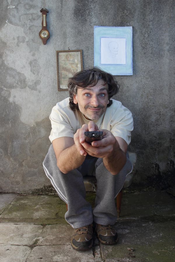 Smiling Man with Remote Control Stock Image - Image of indoor ...