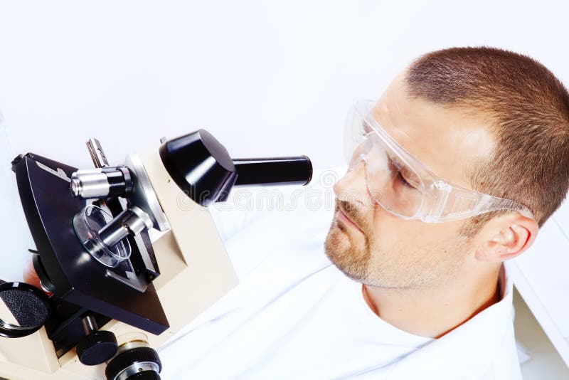 Smiling Man Researching on a Microscope Stock Photo - Image of person ...