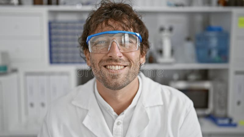 A Smiling Man in Safety Goggles Inside a Laboratory, Portraying a ...