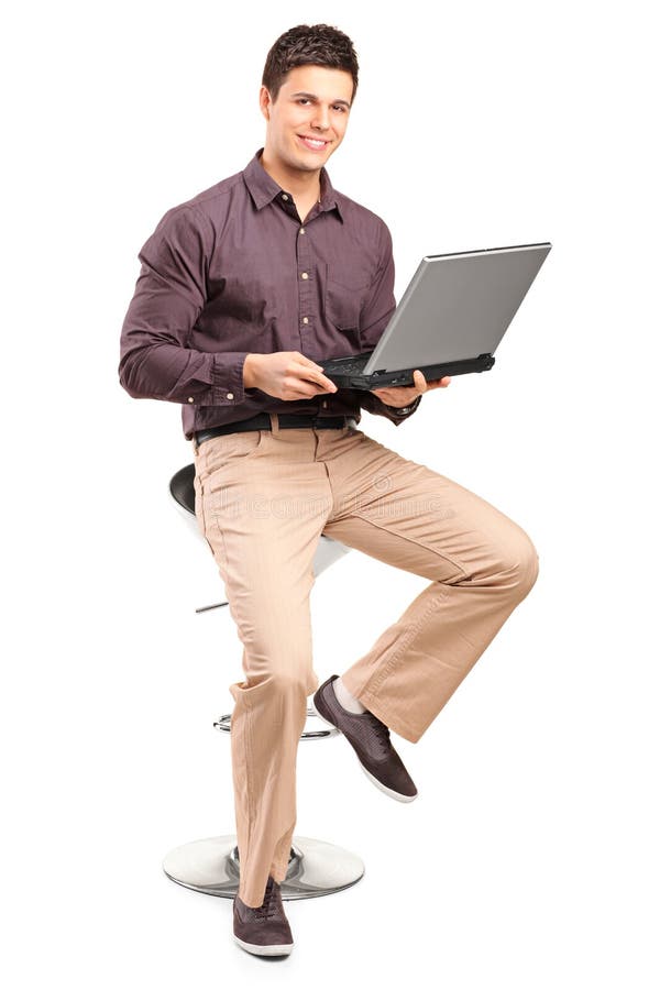 A Smiling Man Sitiing on a High Chair and Working on a Laptop Stock ...