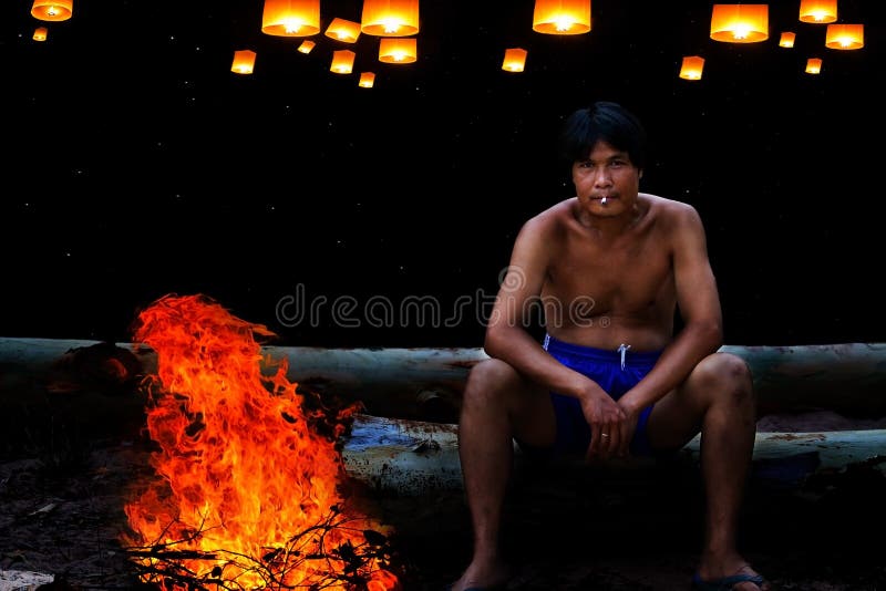 Smiling Man Sitting by the Fire Stock Photo - Image of person, fire ...
