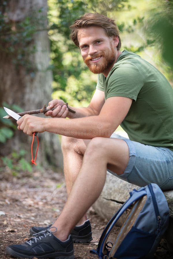 Smiling Man Sitting in Forest Looking at Camera Stock Image - Image of ...