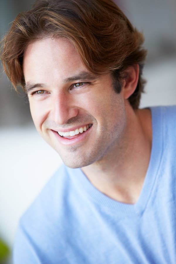 Smiling Man Sitting on Sofa Stock Image - Image of indoors, adult: 31347565