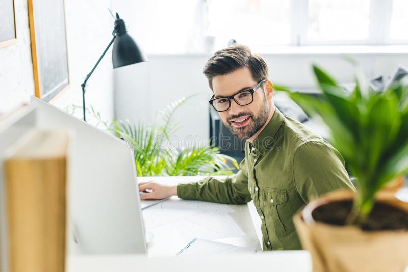 Smiling Man Sitting by Table with Computer Stock Image - Image of ...