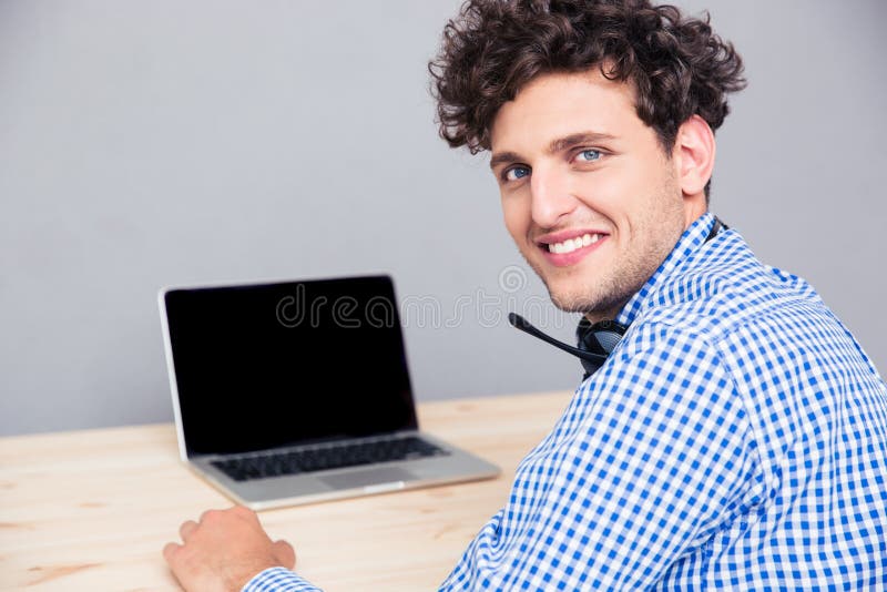 Smiling Man Sitting at the Table with Laptop Stock Photo - Image of ...