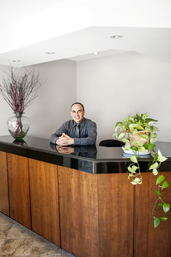 Smiling Man Standing at Office Reception Stock Photo - Image of ...