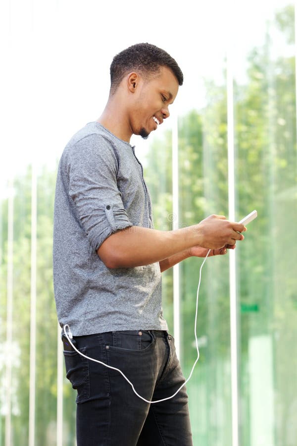 Smiling Man Standing and Using Smart Phone Outside Stock Image - Image ...