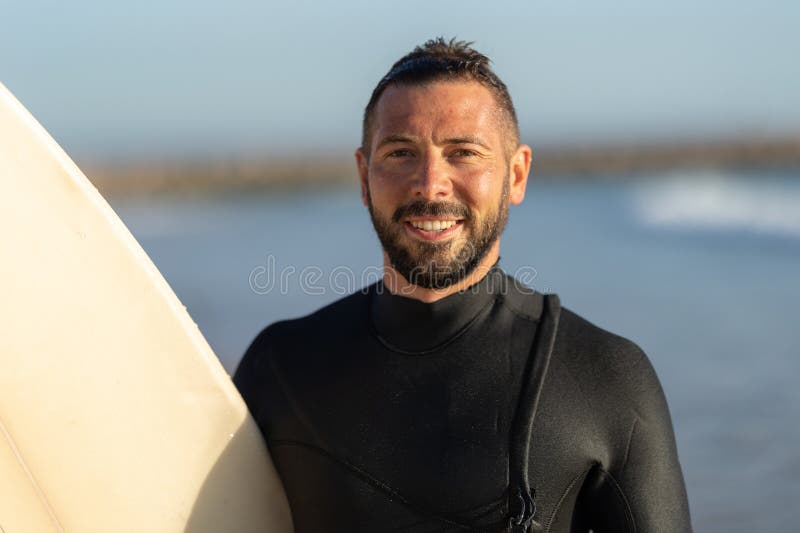Smiling Man Surfer in a Wetsuit Stock Image - Image of surfing, nature ...