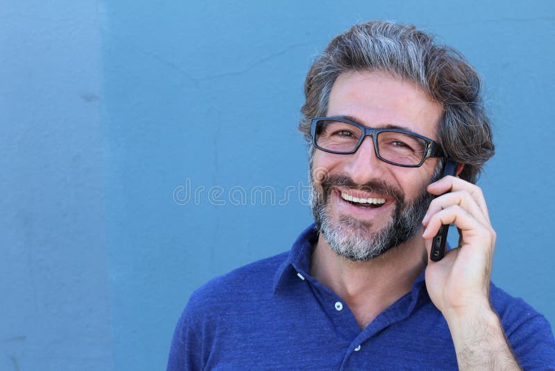 Smiling Man Talking on a Mobile Phone Isolated Over Blue Stock Photo ...