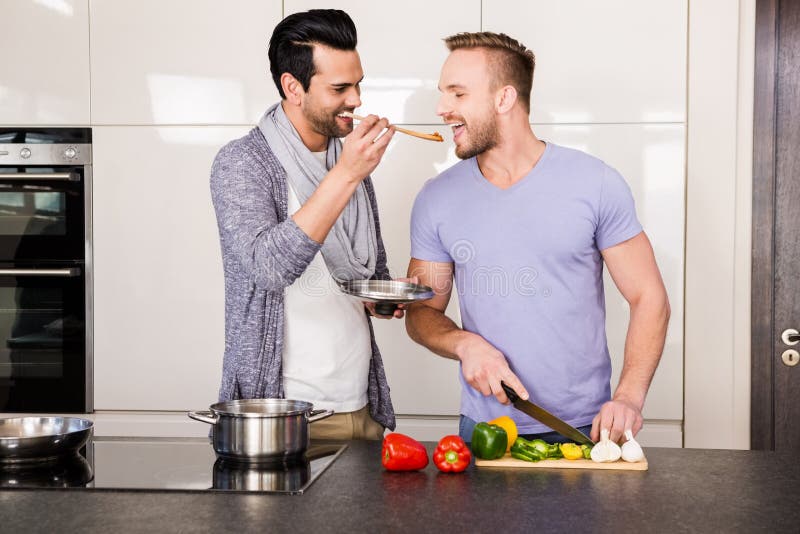 Smiling man tasting food stock image. Image of knife - 66089943