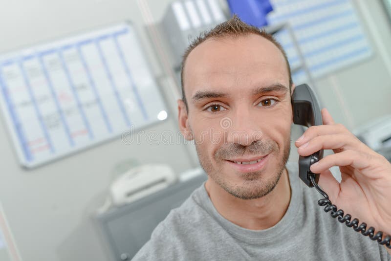 Smiling man on telephone stock photo. Image of sitting - 148278510