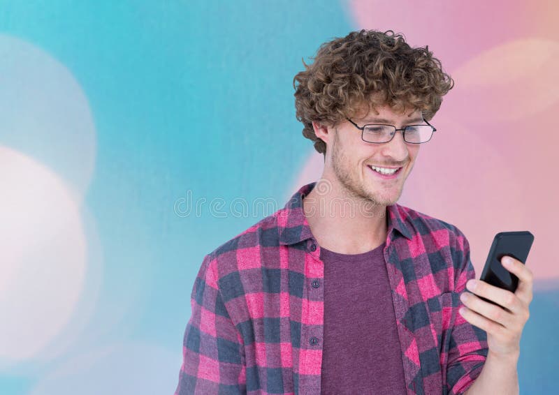 Smiling Man Texting Against Colored Lights Background Stock Image ...