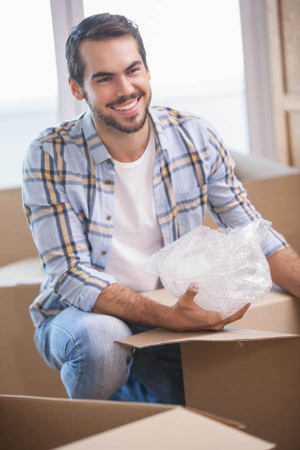 Smiling Man Unpacking Cardboard Boxes Stock Photo - Image of lifestyle ...