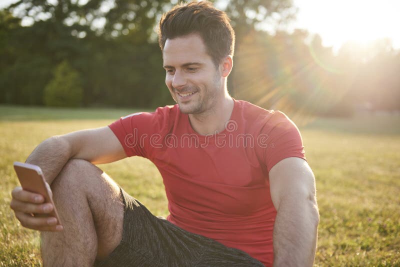 Smiling Man Using Mobile Phone after Workout Stock Photo - Image of ...