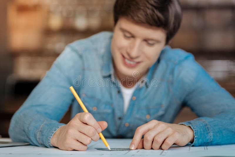 Smiling Man Using a Protractor while Drawing Blueprint Stock Image ...