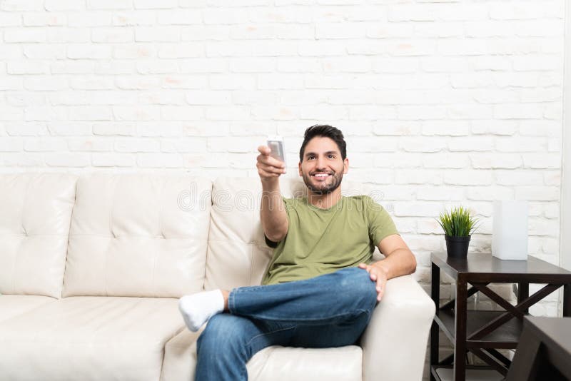 Smiling Man Using Remote Control at Home Stock Image - Image of ...