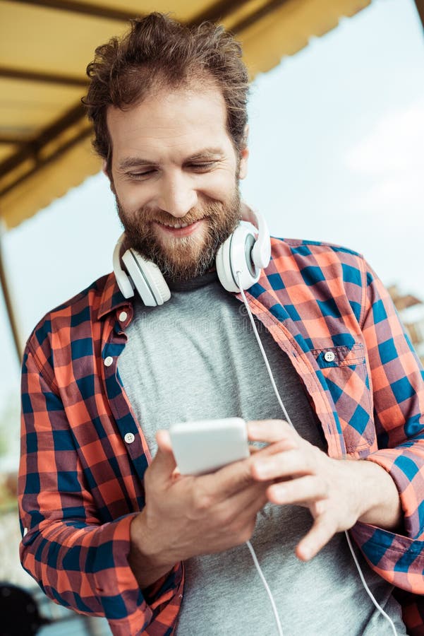 Portrait of Smiling Man with Headphones Hanging on Neck Stock Photo ...