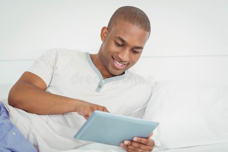 Smiling man using tablet stock image. Image of male, home - 66934251
