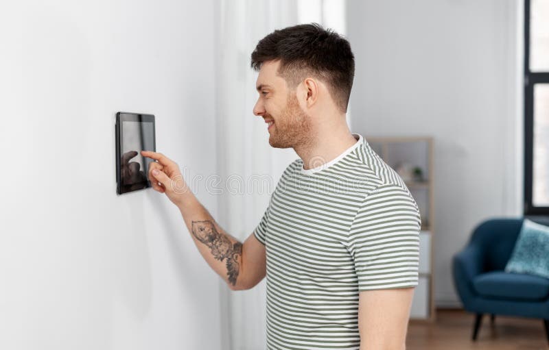 Smiling Man Using Tablet Computer at Smart Home Stock Photo - Image of ...