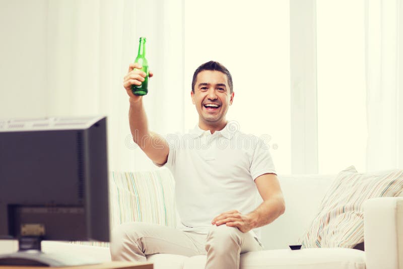 Smiling Man Watching Tv and Drinking Beer at Home Stock Image - Image ...