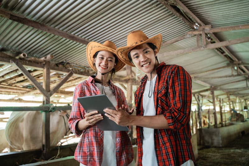 Smiling Man Wearing a Hat Looking at the Camera with the Farm Owner ...