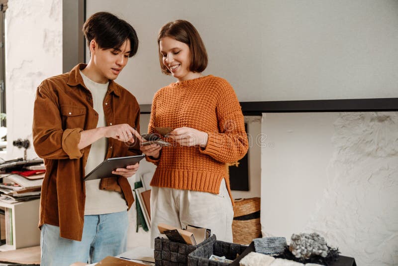 Smiling Man and Woman Architects Choosing Materials for Interior Design ...