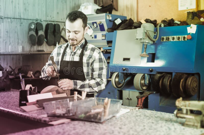 Smiling Man Worker Using Tools for Fixing Shoe Stock Photo - Image of ...