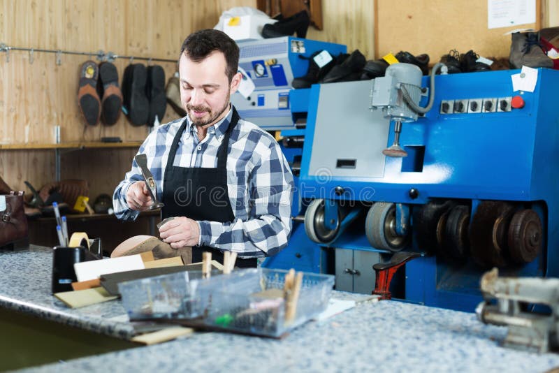 Smiling Man Worker Using Tools for Fixing Shoe Stock Photo - Image of ...