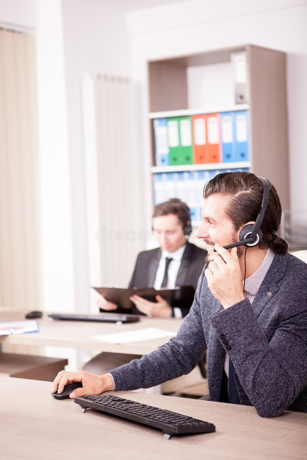 Smiling Man Working at Customer Service Support in the Office Stock ...