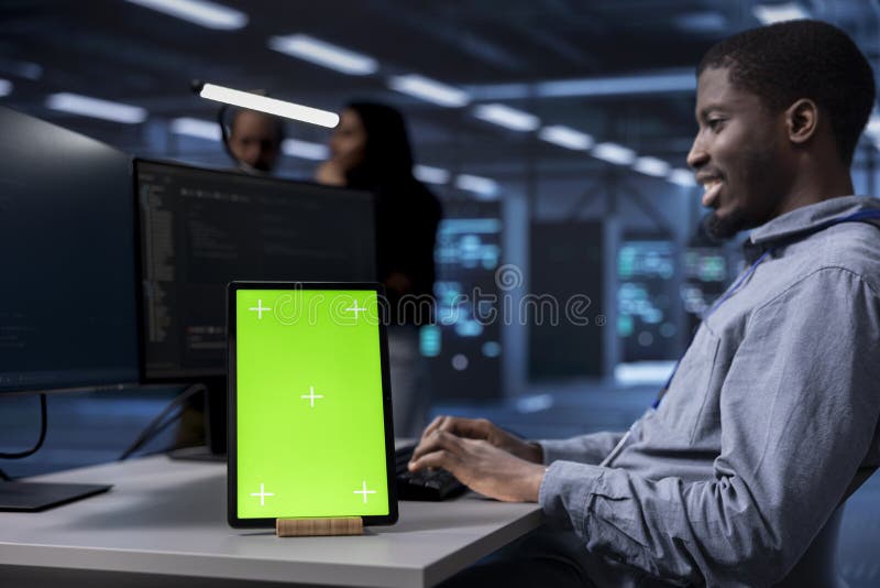 Smiling Man Working on Green Screen Tablet in Modern Data Center Stock ...
