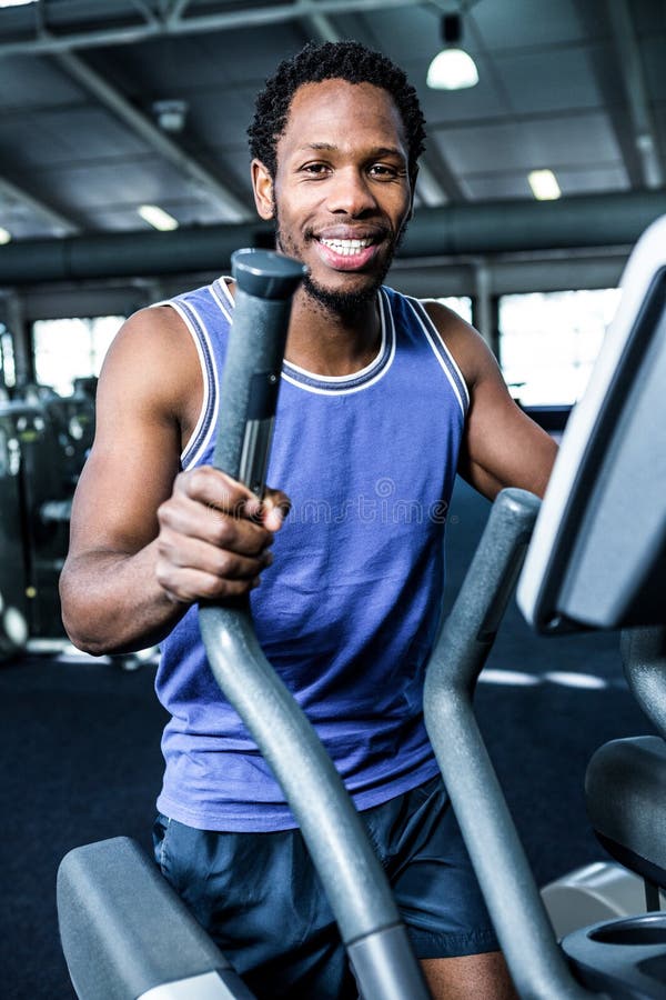 Smiling Man Working Out on the Machine Stock Photo - Image of club ...