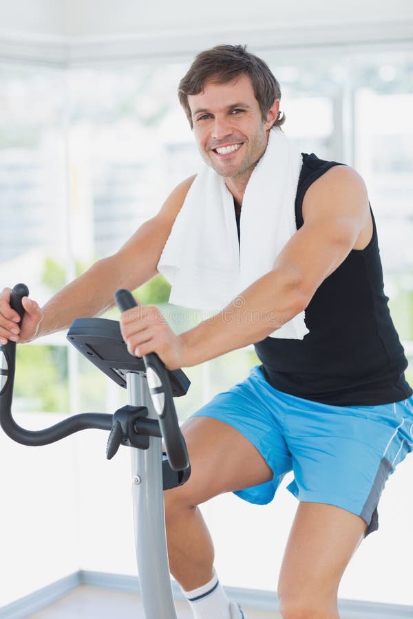 Smiling Man Working Out at Spinning Class in Bright Gym Stock Image ...