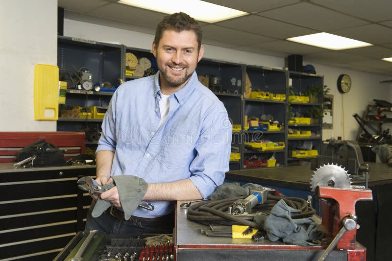 Smiling Man in Workshop with Tools Stock Image - Image of mechanic ...