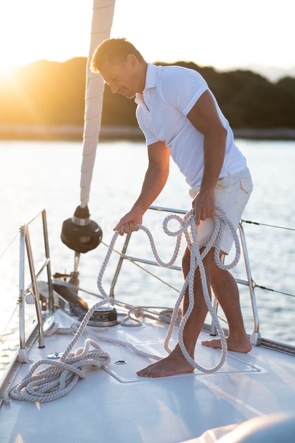 Smiling Man Yacht Fixing Rope Stock Photos - Free & Royalty-Free Stock ...