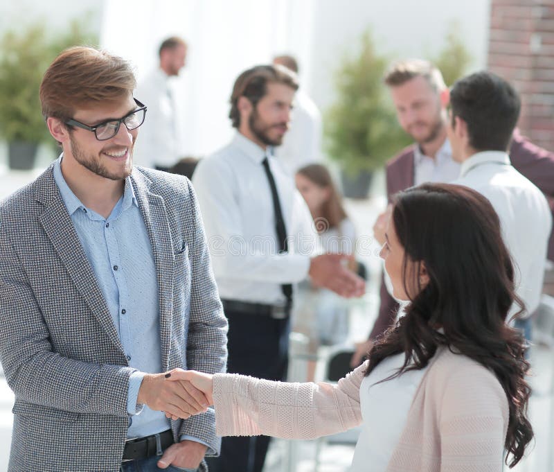 Smiling Manager Greeting the Customer in a Modern Office. Stock Photo ...