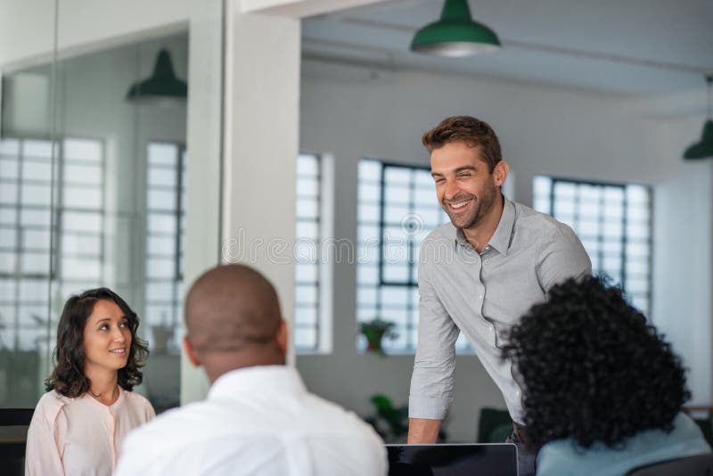 Smiling Manager Having a Meeting with His Diverse Staff Stock Photo ...