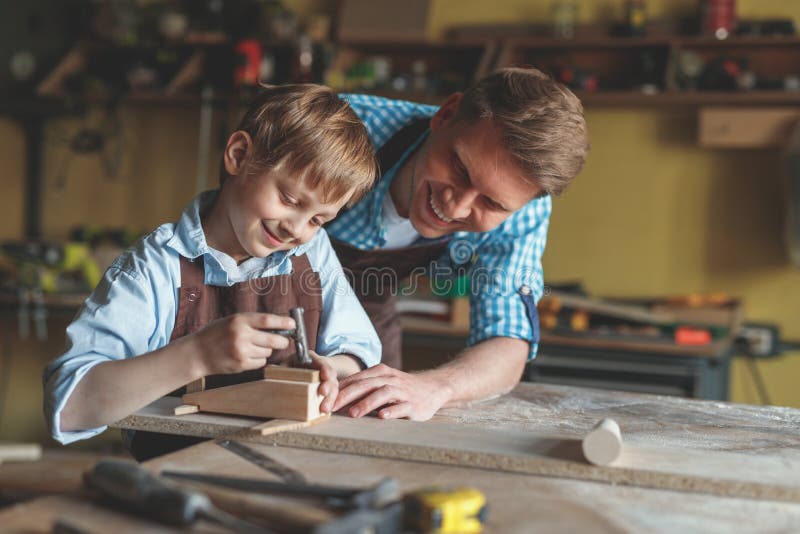 Smiling Master and a Little Boy at Work Stock Image - Image of parent ...