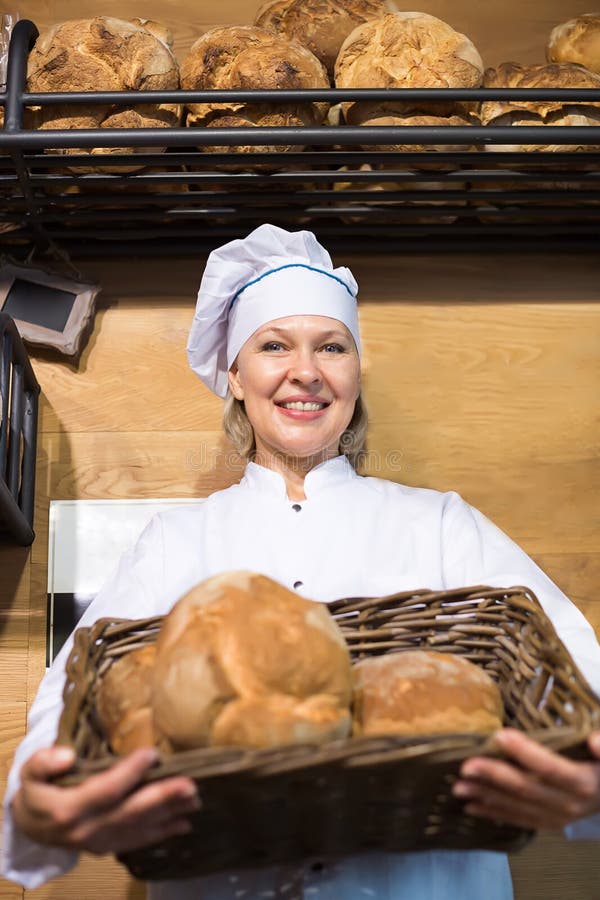 Smiling Mature Bakery Employee Working in Bakery Stock Photo - Image of ...