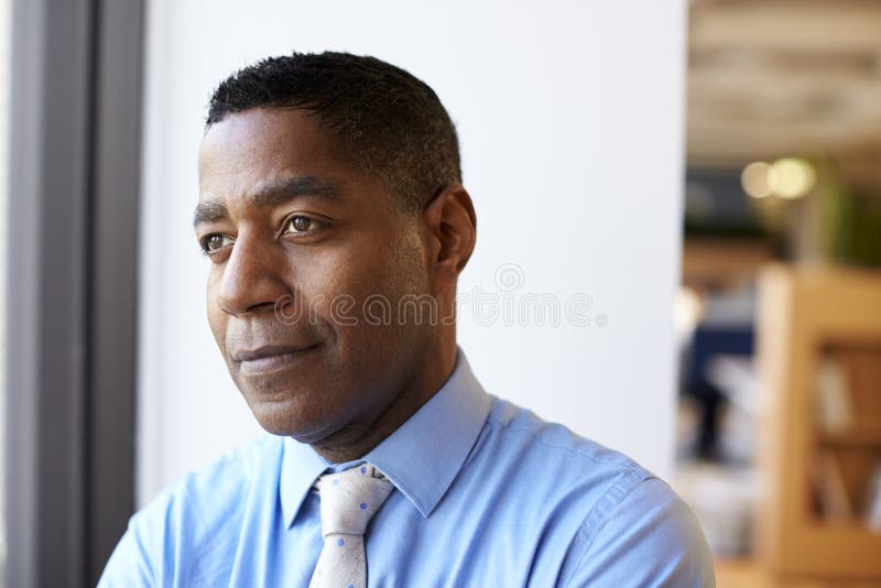 Smiling Mature Businessman in Modern Office Standing by Window Stock ... Smiling Mature Businessman in Modern Office Standing by Window Stock ...