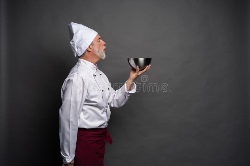 Smiling Mature Male Chef with Bowl in Hands on Black Background. Stock ...