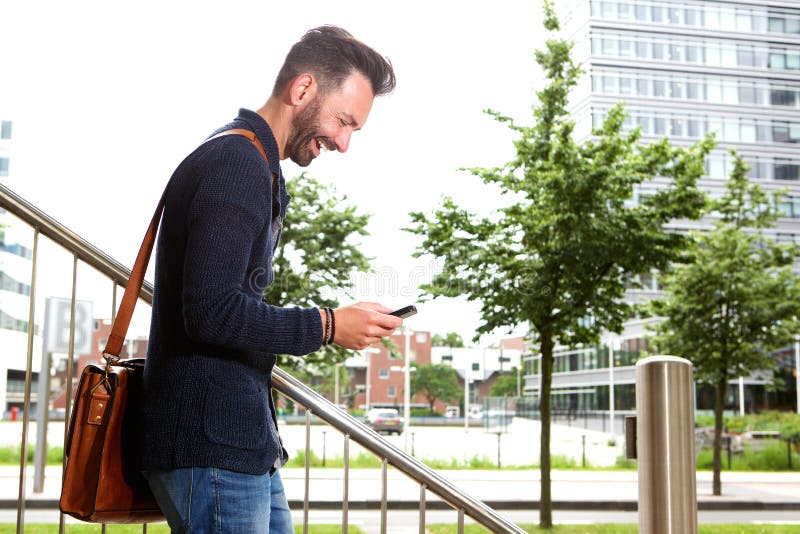 Smiling Mature Man Reading Text Message on Mobile Phone Stock Image ...