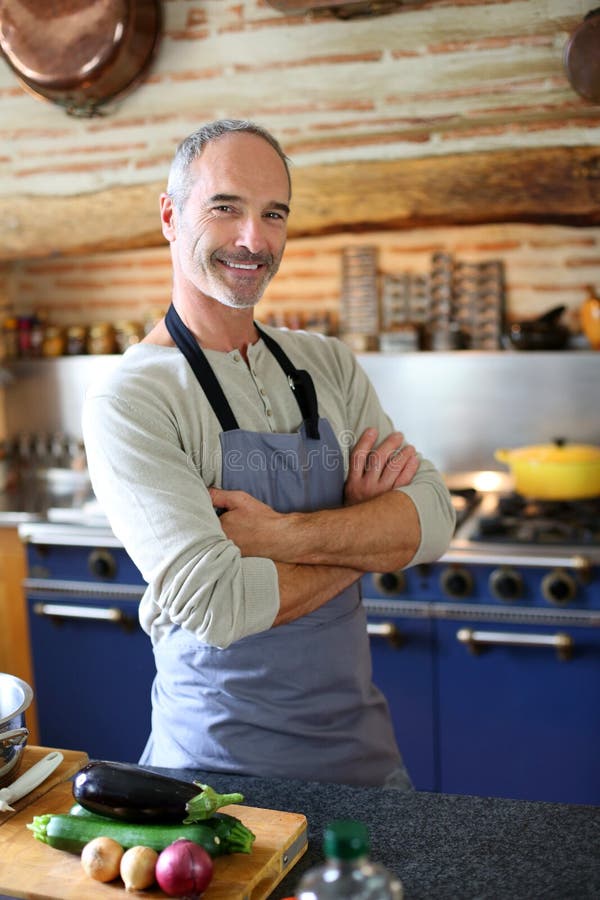 Smiling Mature Man Standing In Kitchen Stock Photo - Image of smile ...