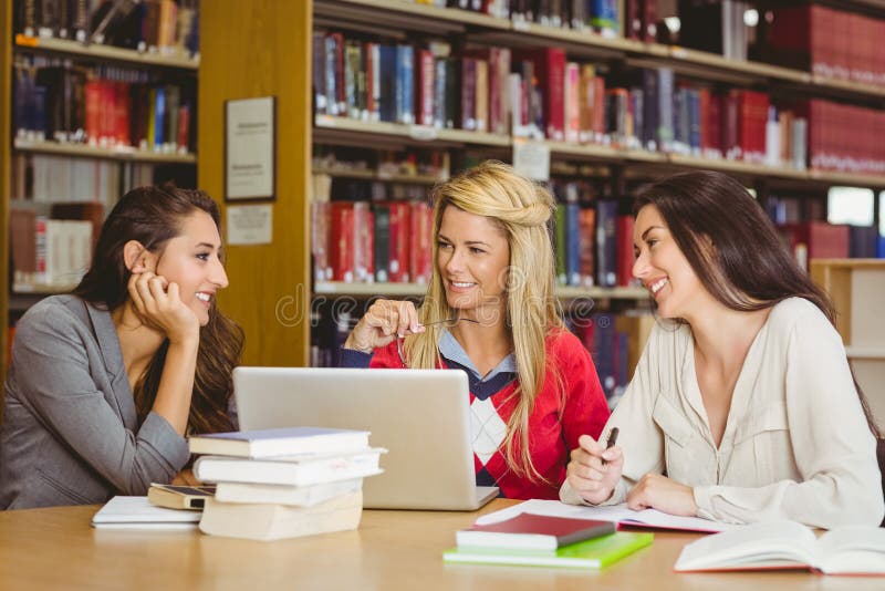 Smiling Mature Student with Classmates Using Laptop Stock Photo - Image ...