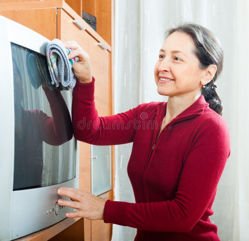 Smiling Mature Woman Dusting TV Stock Image - Image of people, polish ...