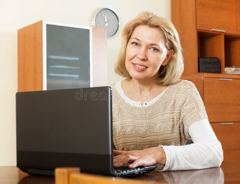 Mature Woman Works on Laptop Stock Photo - Image of fifties, caucasian ...