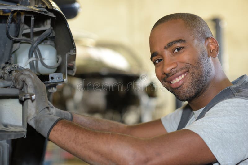 Smiling Mechanic Fixing Car Engine in Garage Stock Photo - Image of ...