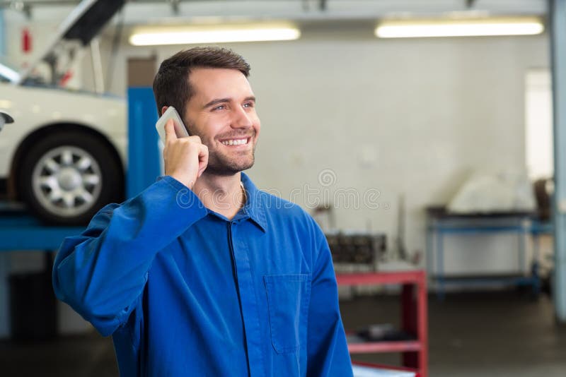 Conceptual Image of Mechanic Talking on Mobile Phone while Looking at ...