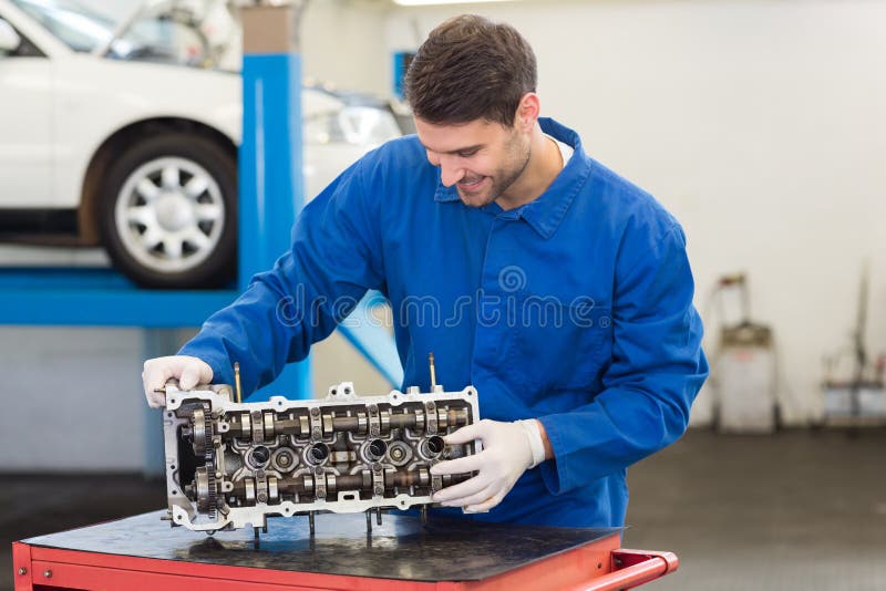 Smiling Mechanic Working on Engine Stock Photo - Image of smiling ...